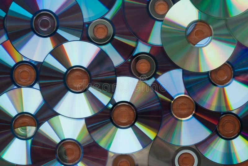 A Lot of Computer Cd Disks Reflecting on a Wooden Surface, Background ...