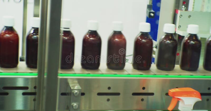 A Lot of Identical Plastic Bottles Move Quickly Along the Conveyor ...