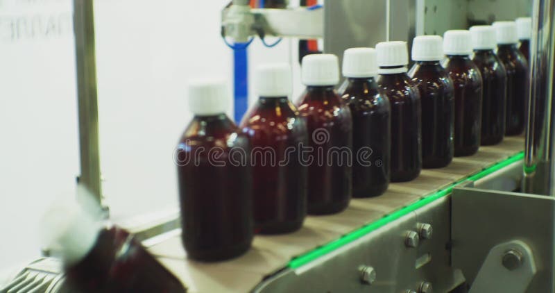 A Lot of Identical Plastic Bottles Move Quickly Along the Conveyor ...