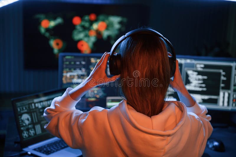 A Lot of Information on Displays. Young Professional Female Hacker is ...