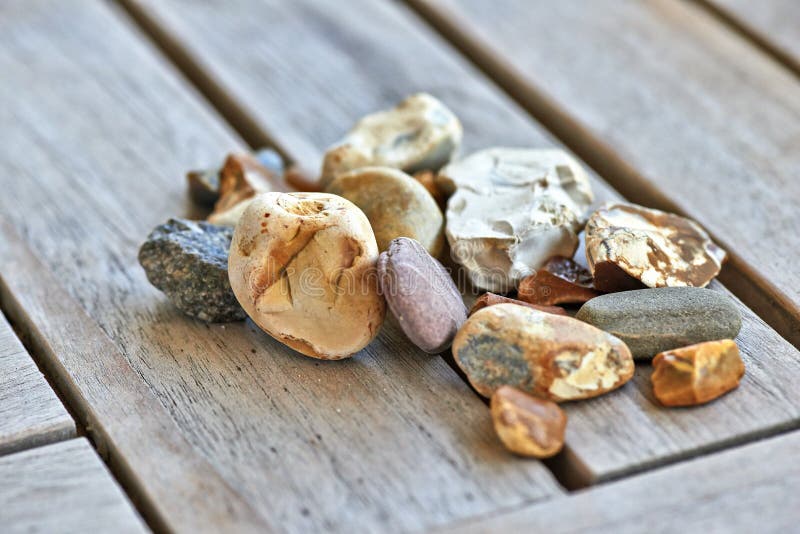 Lot of Little Rocks on Wooden Table Stock Photo - Image of stone, care ...