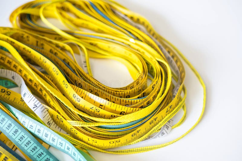 A Lot of Multi-colored Centimeter and Inch Measuring Tapes Lie on a ...