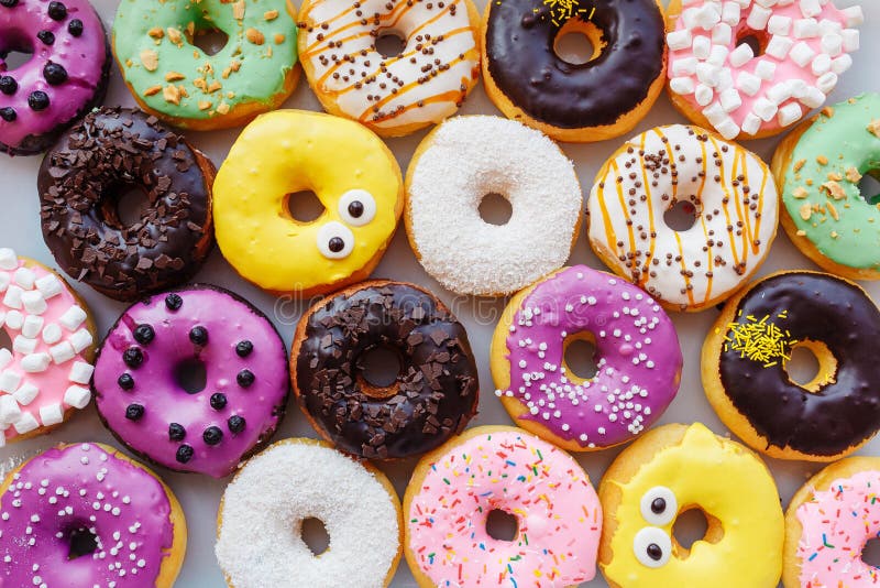 A Lot of Multi-colored Donuts with Different Fillings, Top View Stock ...