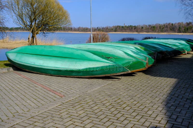 A Lot of Plastic Boats in Green Color on the Shore Stock Photo - Image ...