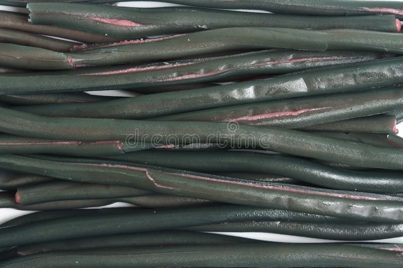 Lot Raspberry and Blackberry Licorice Sticks on White Background Stock ...
