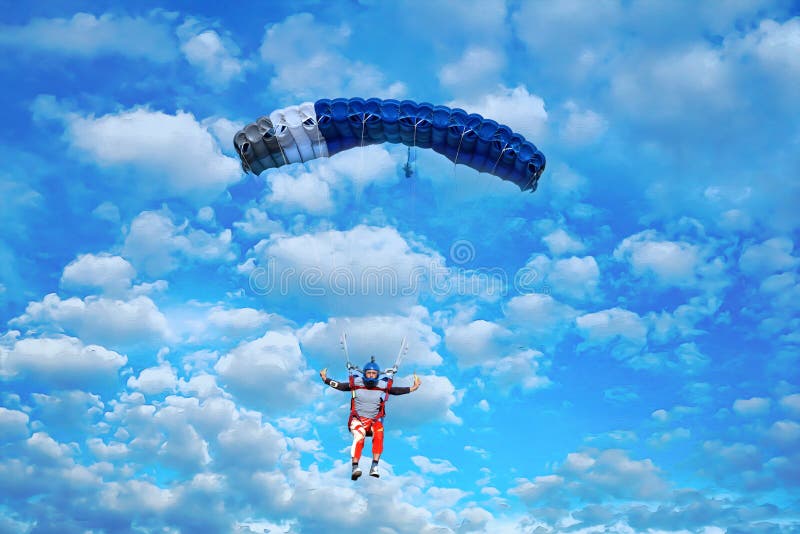 Skydiver with a Dark Blue Parachute on the Background a Blue Sky, Close ...