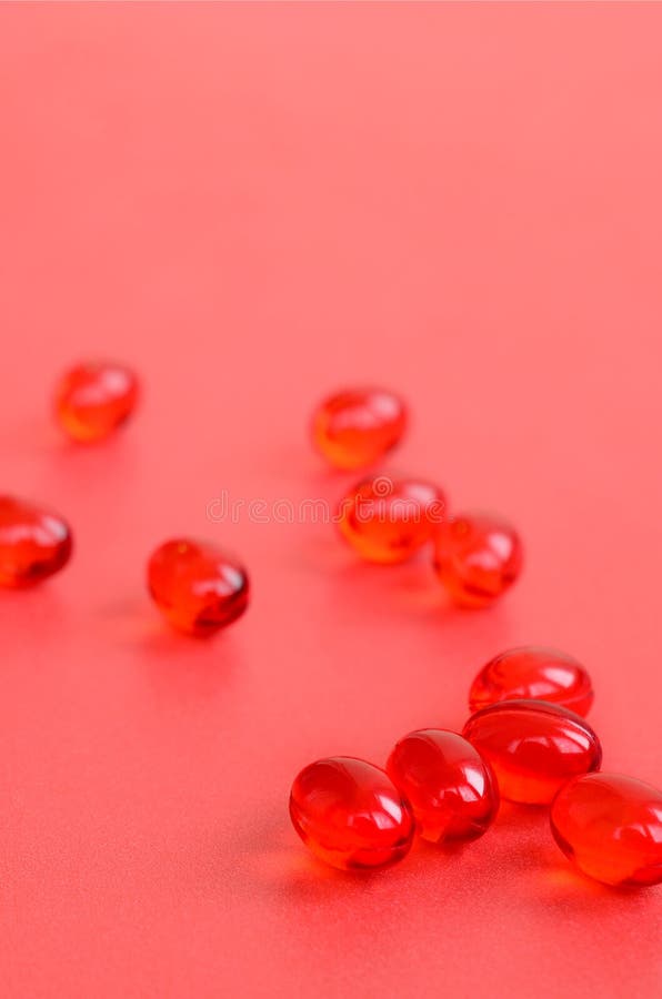 A Lot of Transparent Red Tablets Lie on the Red Surface Stock Photo ...
