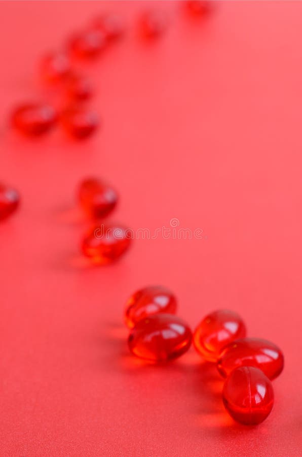A Lot of Transparent Red Tablets Lie on the Red Surface Stock Photo ...