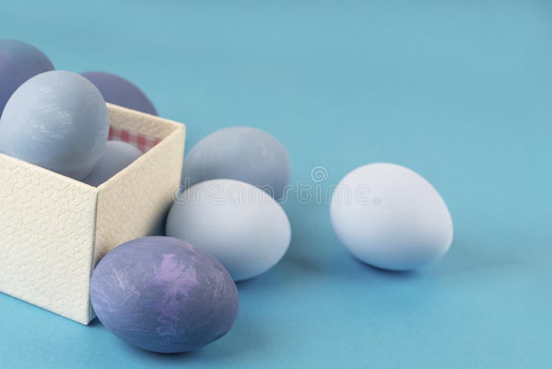 Lots of Blue and Light Blue Easter Eggs Next To an Open Gift Box ...