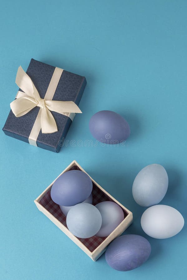 Lots of Blue and Light Blue Easter Eggs Next To an Open Gift Box ...