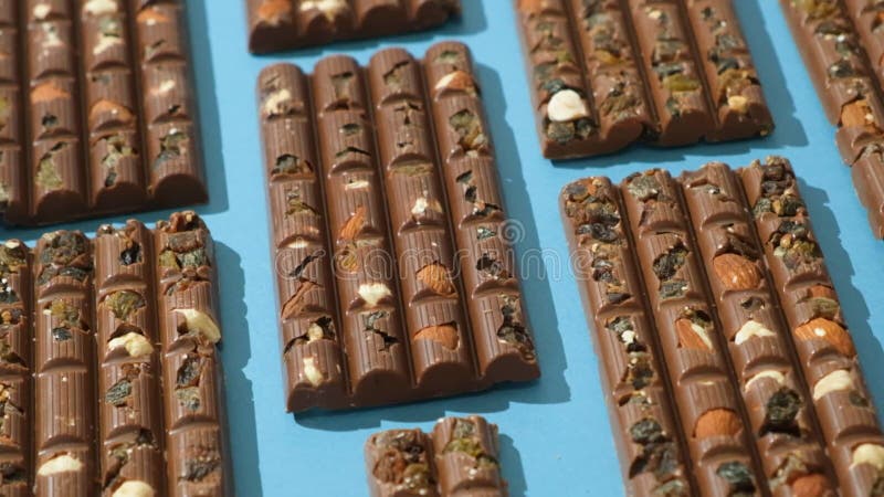 Lots of Chocolate Bars with Nuts and Raisins on a Blue Background Stock ...