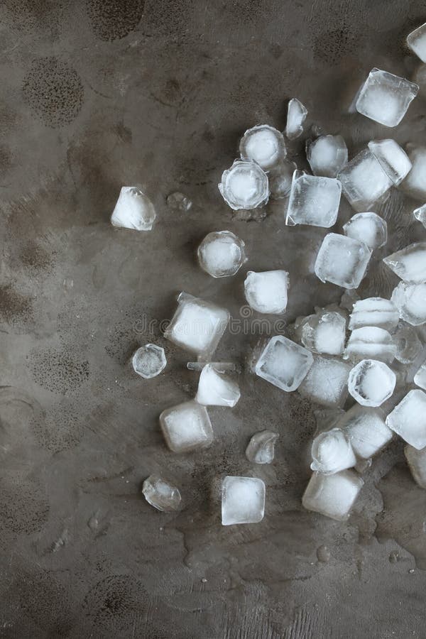 Lots of Small Pieces of Ice on a Brown Table Stock Image - Image of ...
