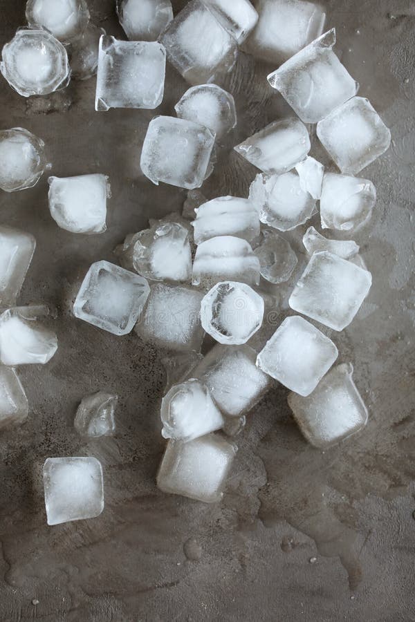Lots of Small Pieces of Ice on a Brown Table Stock Image - Image of ...