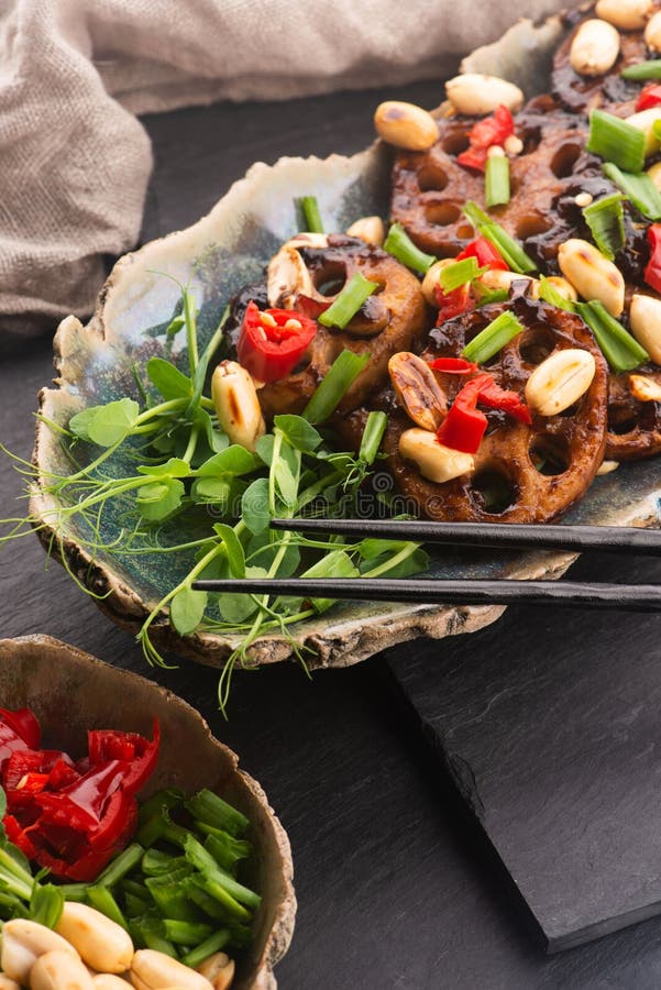 Lotus Root Deep Fried with Sauce Japanese Food on Black Plate Stock ...