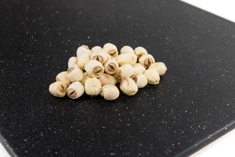 Lotus Seed Pile on a Black Cutting Board Side View Stock Photo - Image ...