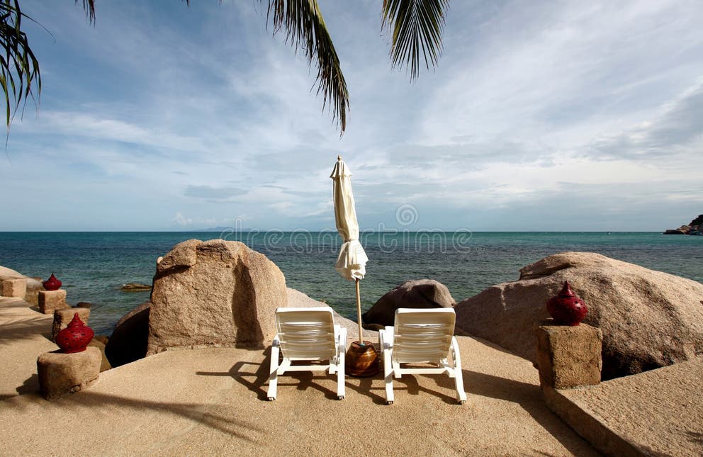 Lounge chairs on the rocks stock photo. Image of samui - 14540188