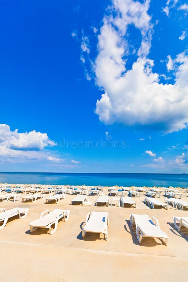 Lounge chairs by the sea stock photo. Image of deckchair - 31424678