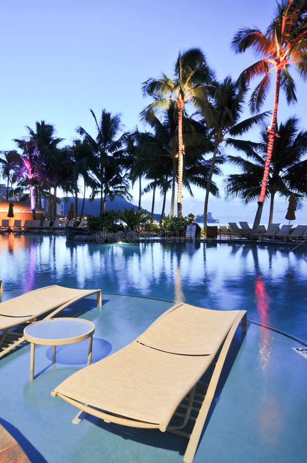 Lounge Chairs by Swimming Pool at Night Time Stock Image - Image of ...