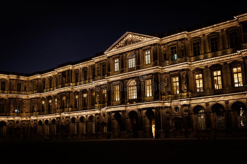 Louvre Museum at Night. a Large Building with a Lot of Windows Lit Up ...
