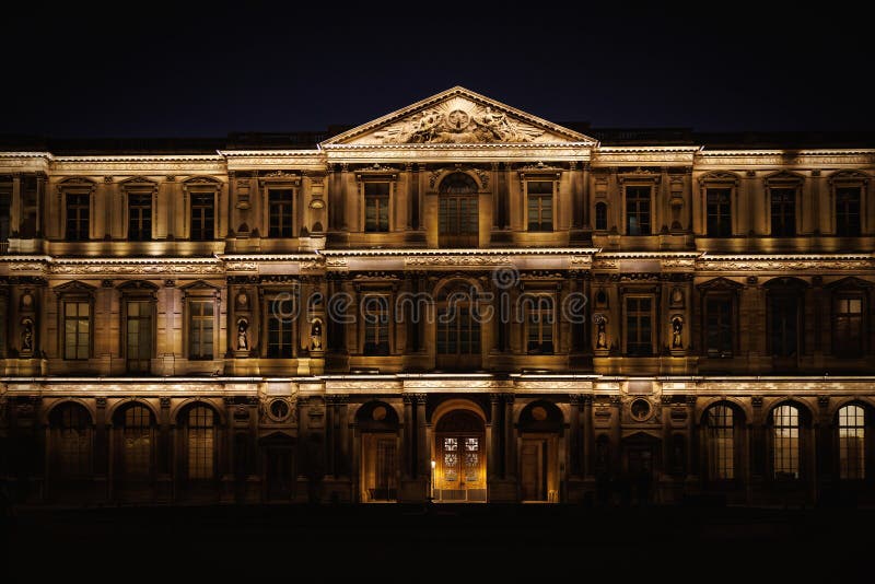Louvre Museum at Night. a Large Building with a Lot of Windows Lit Up ...