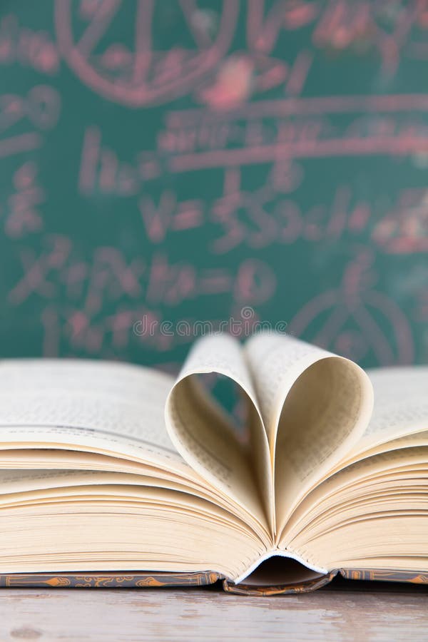 Love Folded from an Open Book in Front of the Blackboard Stock Image ...
