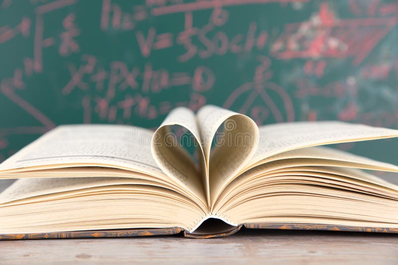 Love Folded from an Open Book in Front of the Blackboard Stock Photo ...