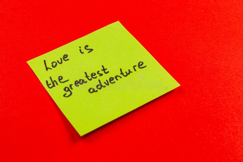 Love is the Greatest Adventure Written on a Sticky Note on a Red ...