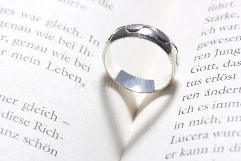 Ring Casting a Heart-shaped Shadow in a Book. Stock Photo - Image of ...