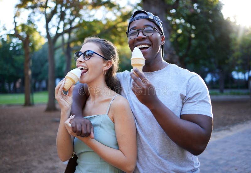 Love Ice Cream Or Couple Of Friends In A Park Walking On A Romantic