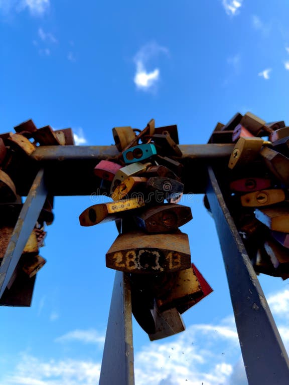Love Locks Hanging on a Bridge Railing Under Blue Sky Stock Photo ...