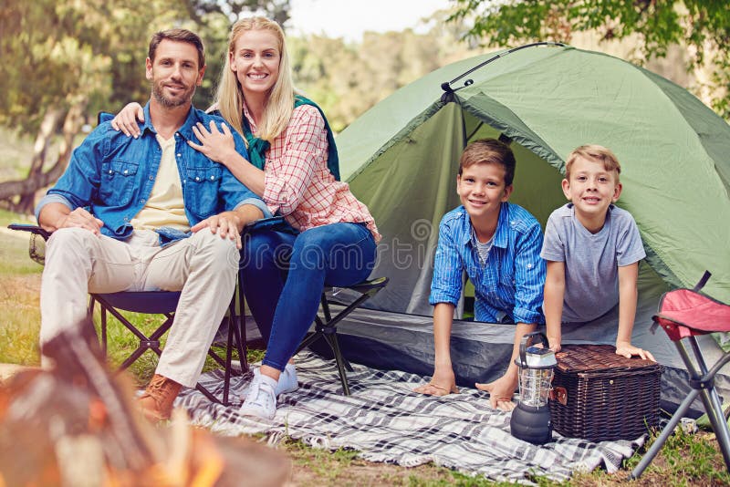 We Love Our Camping Trips. a Family of Four Camping in the Woods. Stock ...