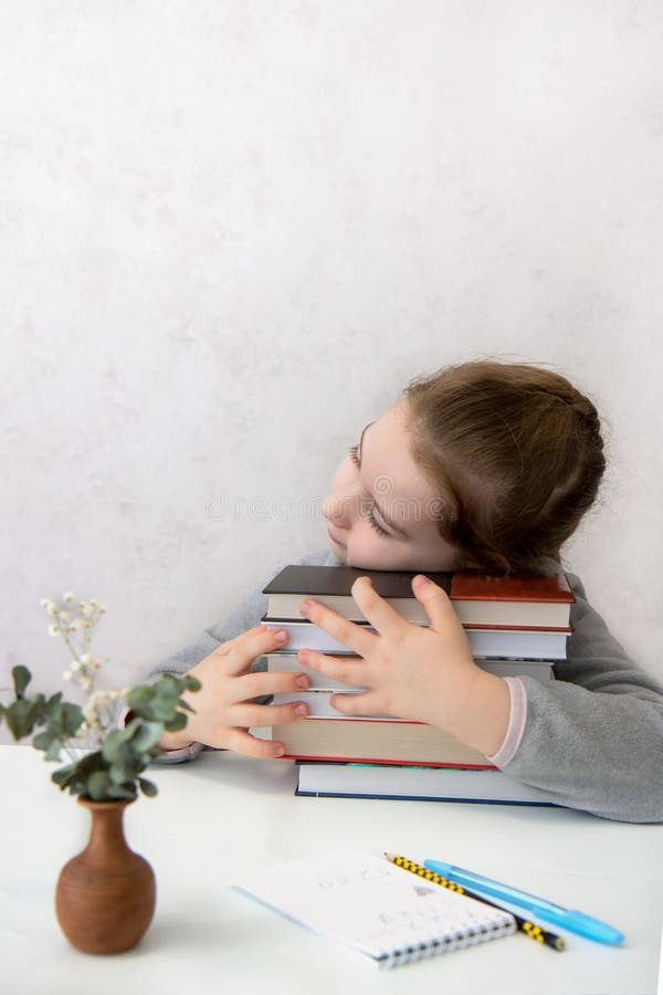 Love of Reading, Little Girl Sitting at the Table Hugging a Stack of ...