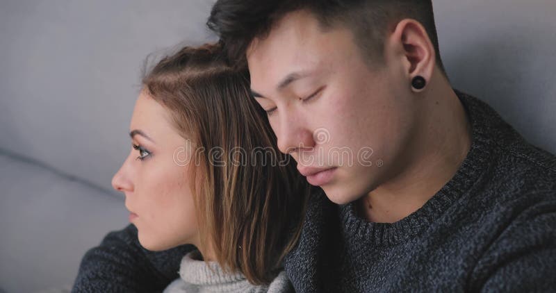 Sad Young Couple Sit Together on Sofa and Hug Stock Video - Video of ...