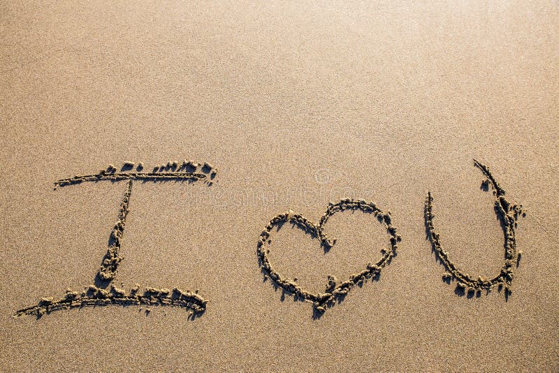 Love sculpted in the sand stock image. Image of abstract - 67671019