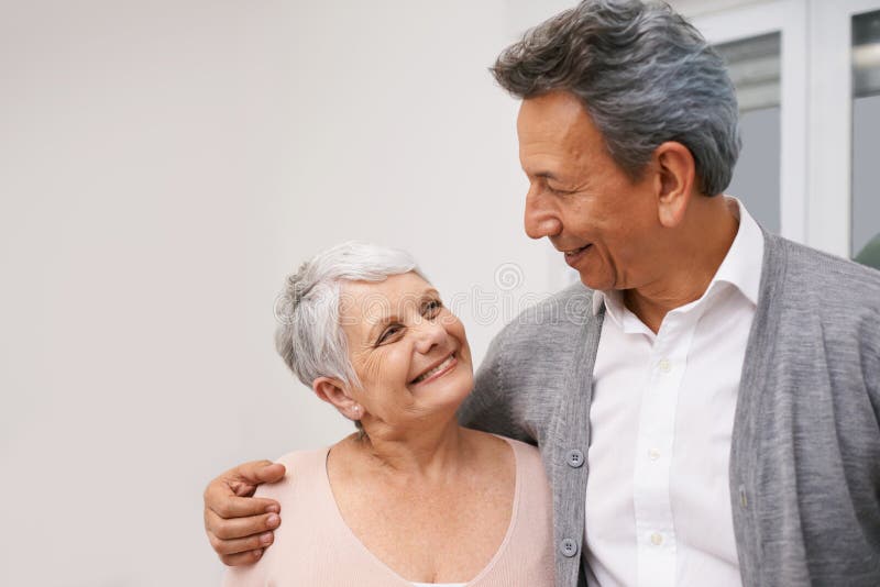 Love Senior Or Couple Hug To Relax In Home Living Room For Bonding