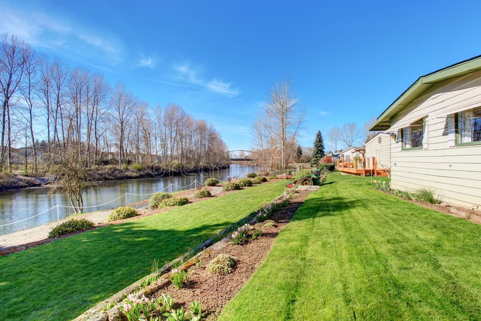 Lovely Back Yard with Grass and River. Stock Photo - Image of grass ...