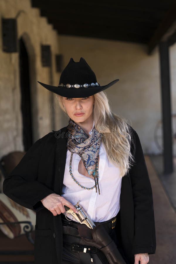 A Lovely Blonde Model Dressed As A Cowgirl Enjoys The American West