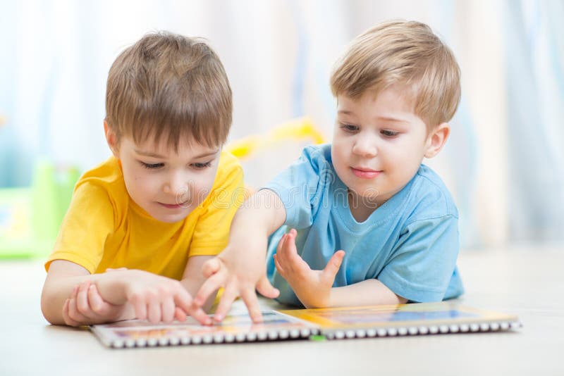 Lovely Children Reading a Book, on the Floor at Stock Photo - Image of ...