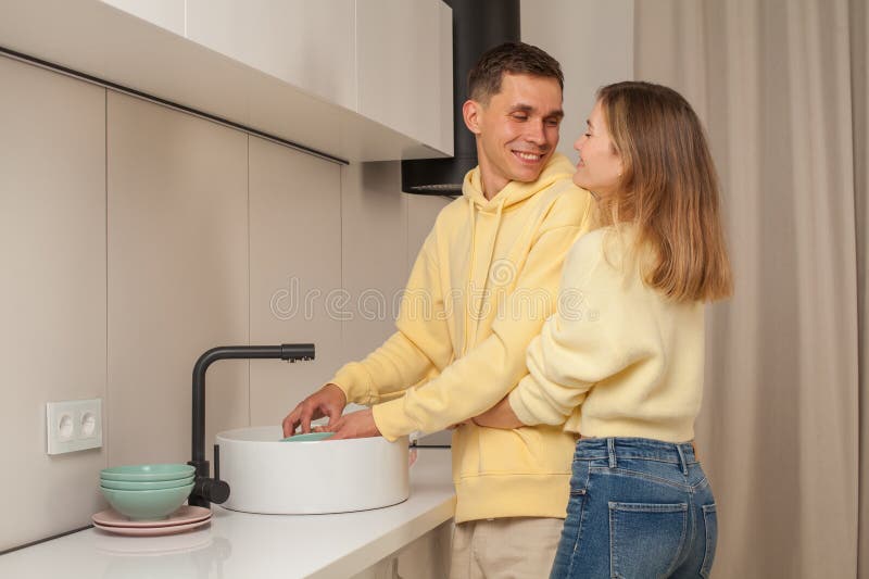 Lovely Couple Laughing Hugging and Washing the Dishes Stock Photo ...