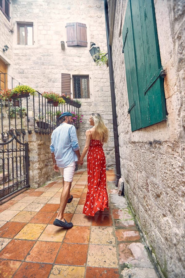 Lovely Date. Couple on Walk. Woman in Red Sultry Summer Dress and ... Lovely Date. Couple on Walk. Woman in Red Sultry Summer Dress and ...