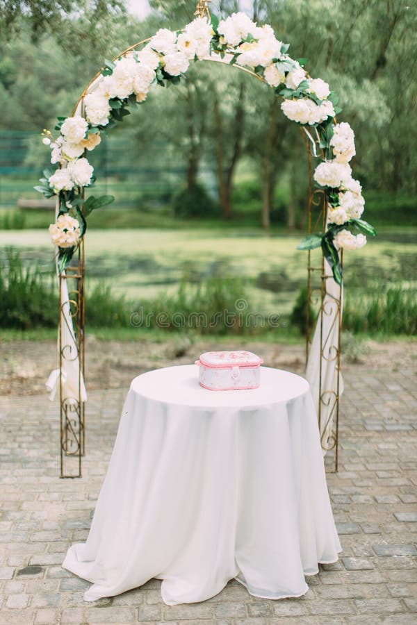 Lovely Decorated Arch with White Flowers Behind the Table with Tiny ...
