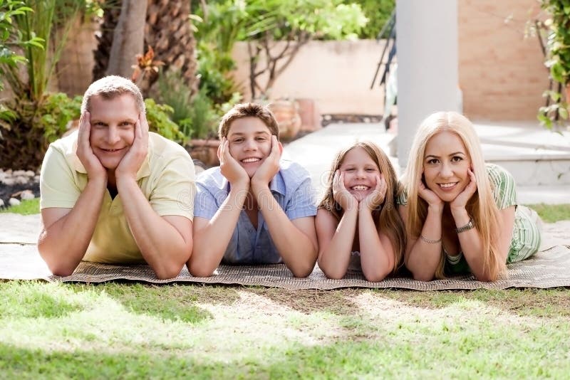 Lovely Family on There Backyard and Looking at You Stock Image - Image ...