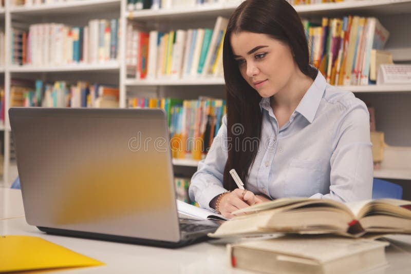 Lovely Female Student Working on Laptop at the Library Stock Photo ...