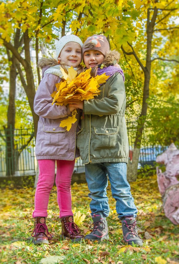 Lovely Girls with Yellow Maple Leaves Stock Photo - Image of kids ...