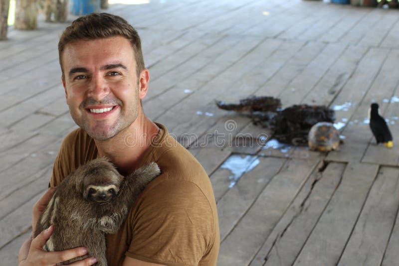 Lovely sloth hugging a man stock image. Image of central - 136742253
