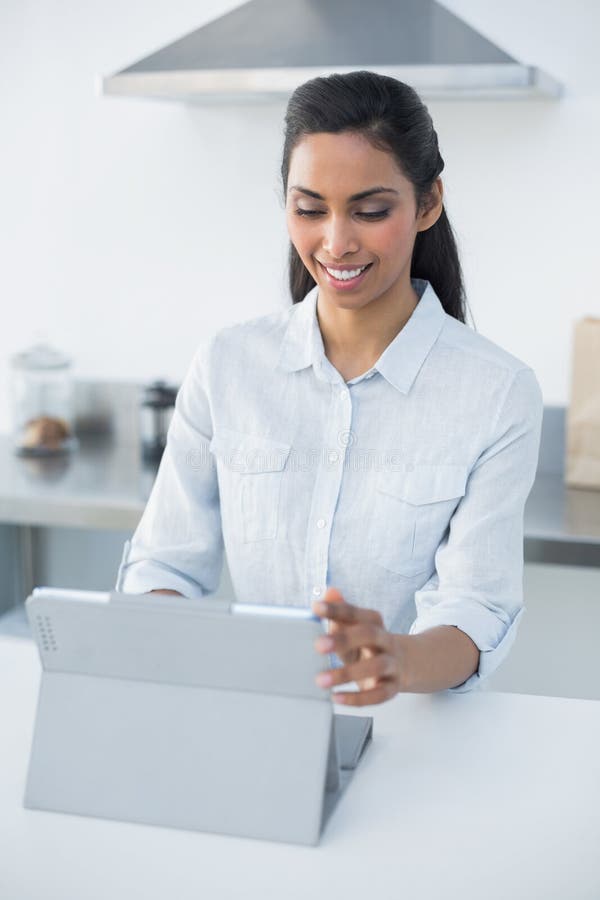 Lovely Smiling Woman Using Her Tablet Standing in Bright Kitchen Stock ...