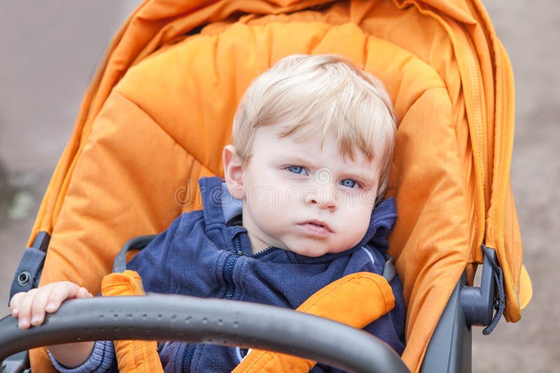 Lovely Toddler Boy Outdoor in Orange Stroller Stock Photo - Image of ...