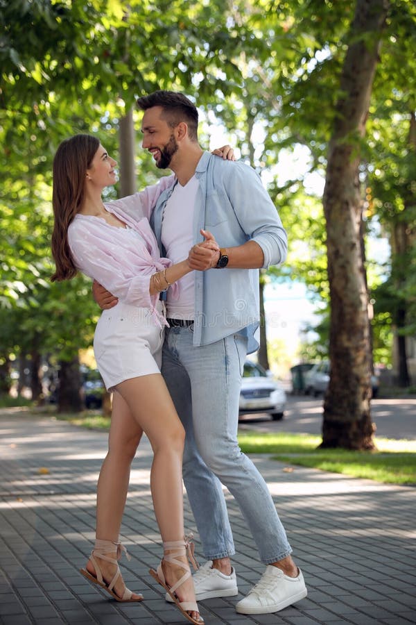 Lovely Young Couple Dancing Together Outdoors on Sunny Day Stock Image ...