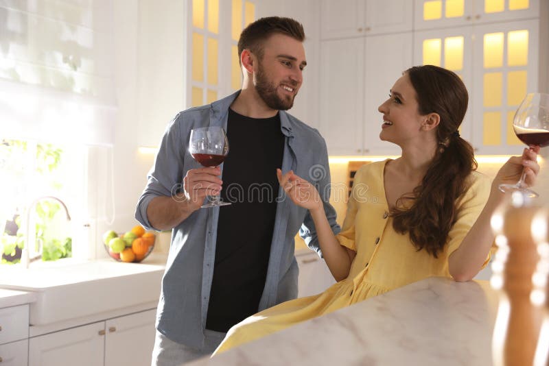 Lovely Young Couple Drinking Wine while Cooking in Kitchen Stock Image ...