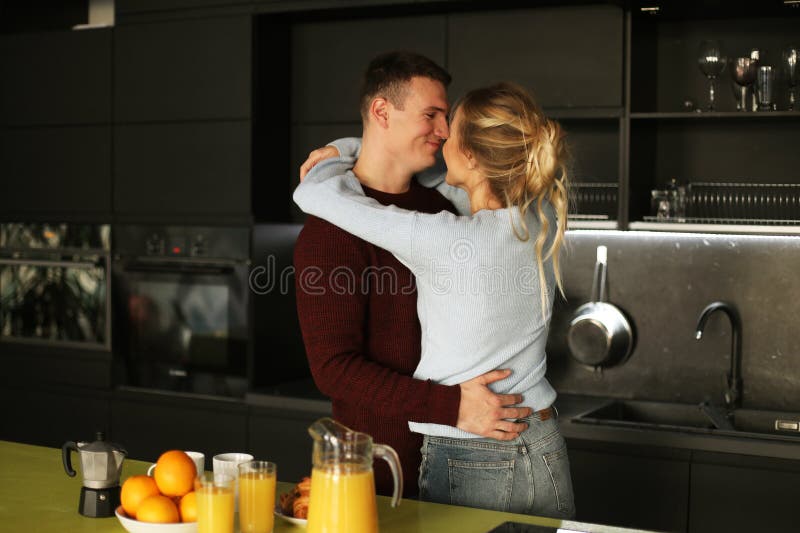 Young Couple Standing and Hugging on a Kitchen at Home Stock Photo ...